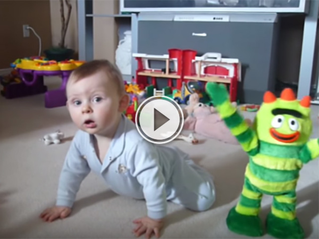 A baby head bangs to a dancing toy song