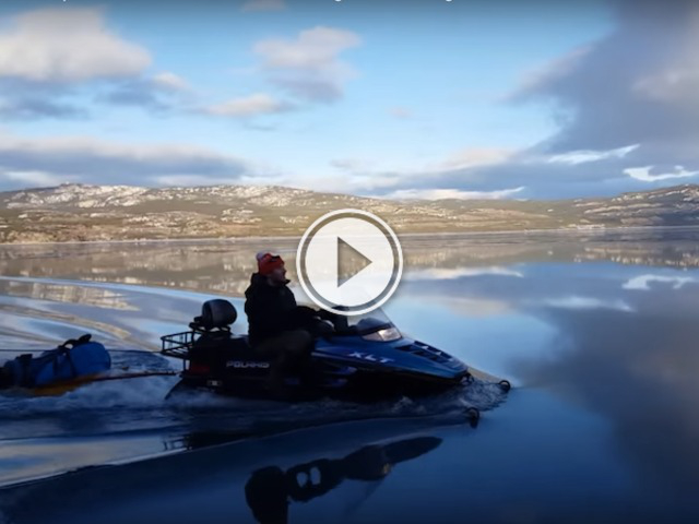 Want to cross a rapidly melting lake? Take the snowmobile! (Video)