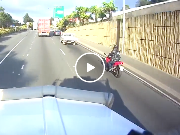 Distracted motorcycle rider lands in truck bed