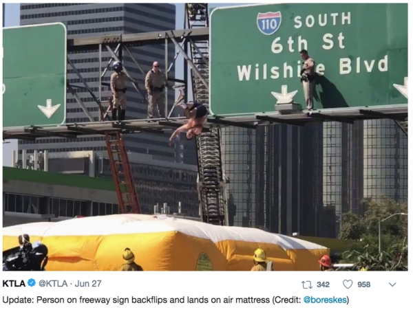 Shirtless vaping guy climbs freeway sign, causes 2-hour traffic jam