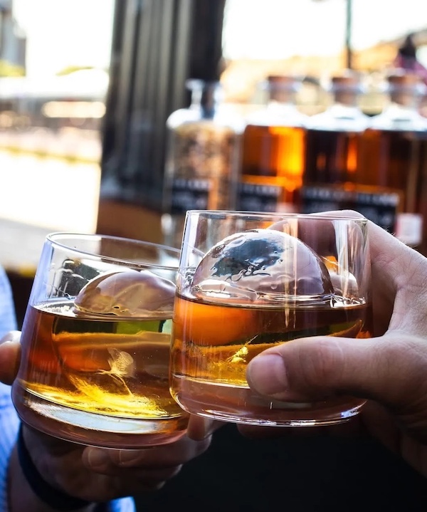 People raise a glass and toast to their friends and family